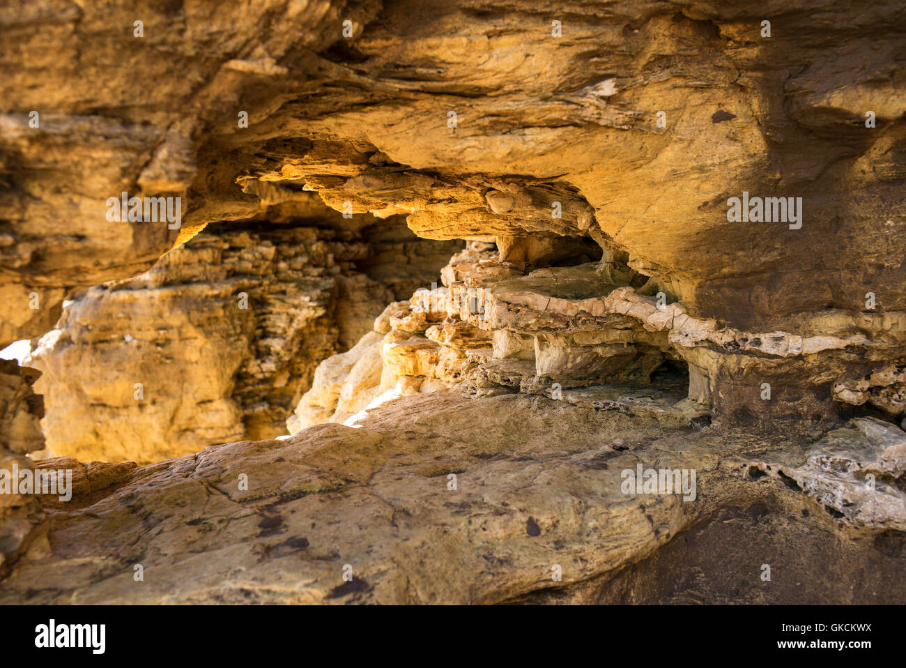 Caves eroded from cliffs of yellow coloured Magnesian Limestone rock at ...