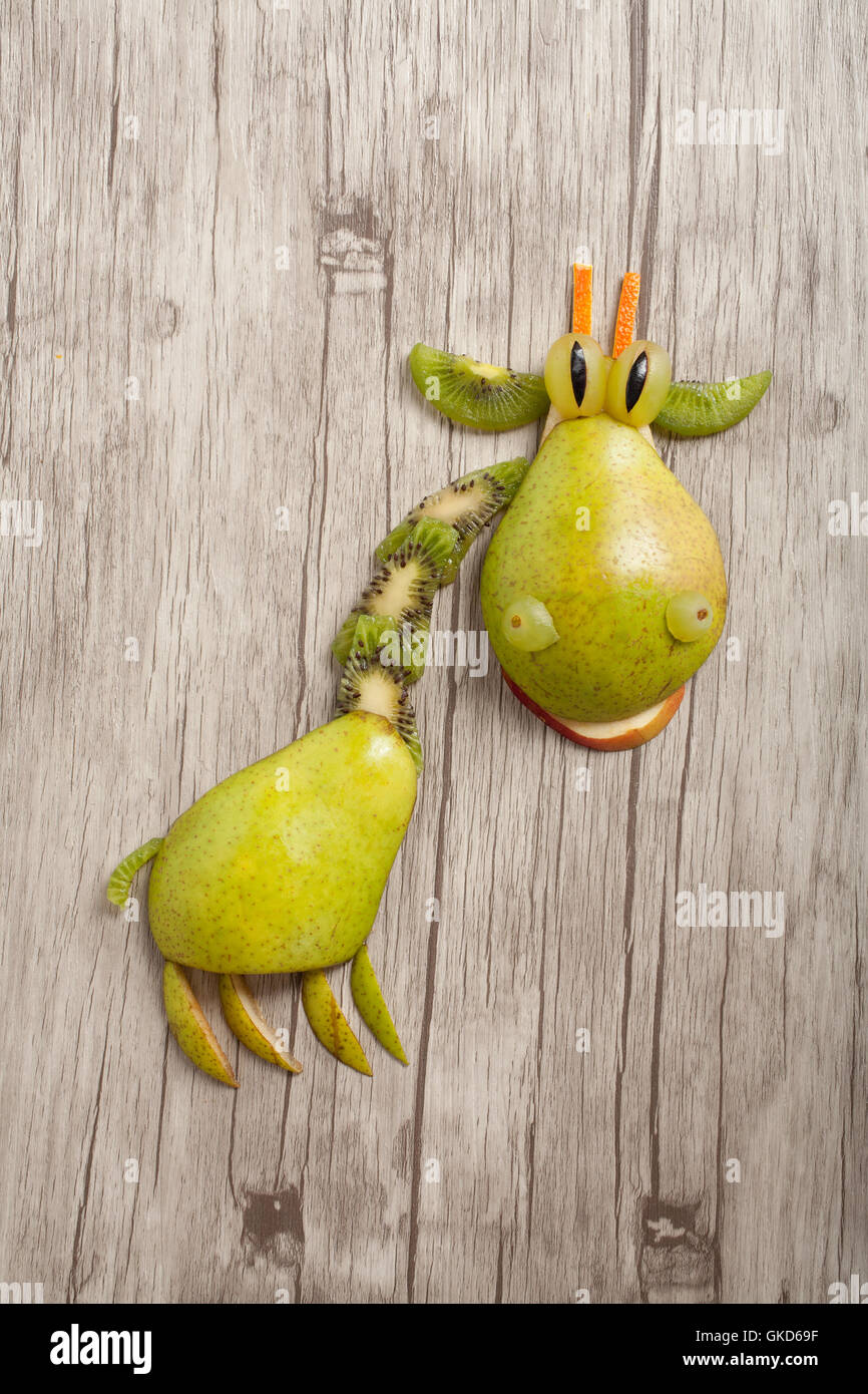 Giraffe made of fruits on wooden background Stock Photo - Alamy