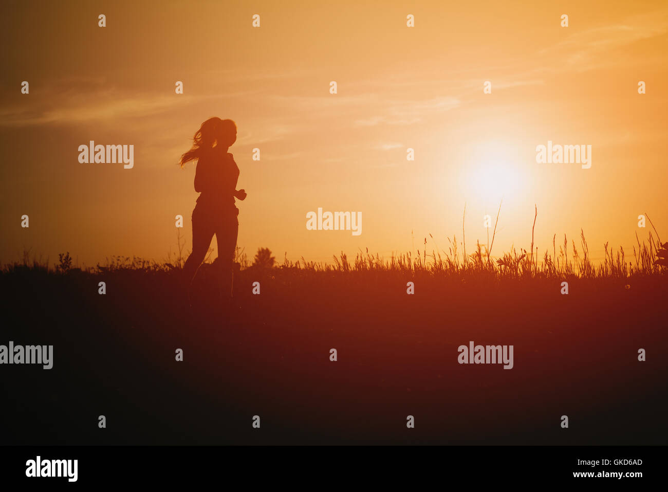 teenage girl runner countryside in sunset Stock Photo - Alamy