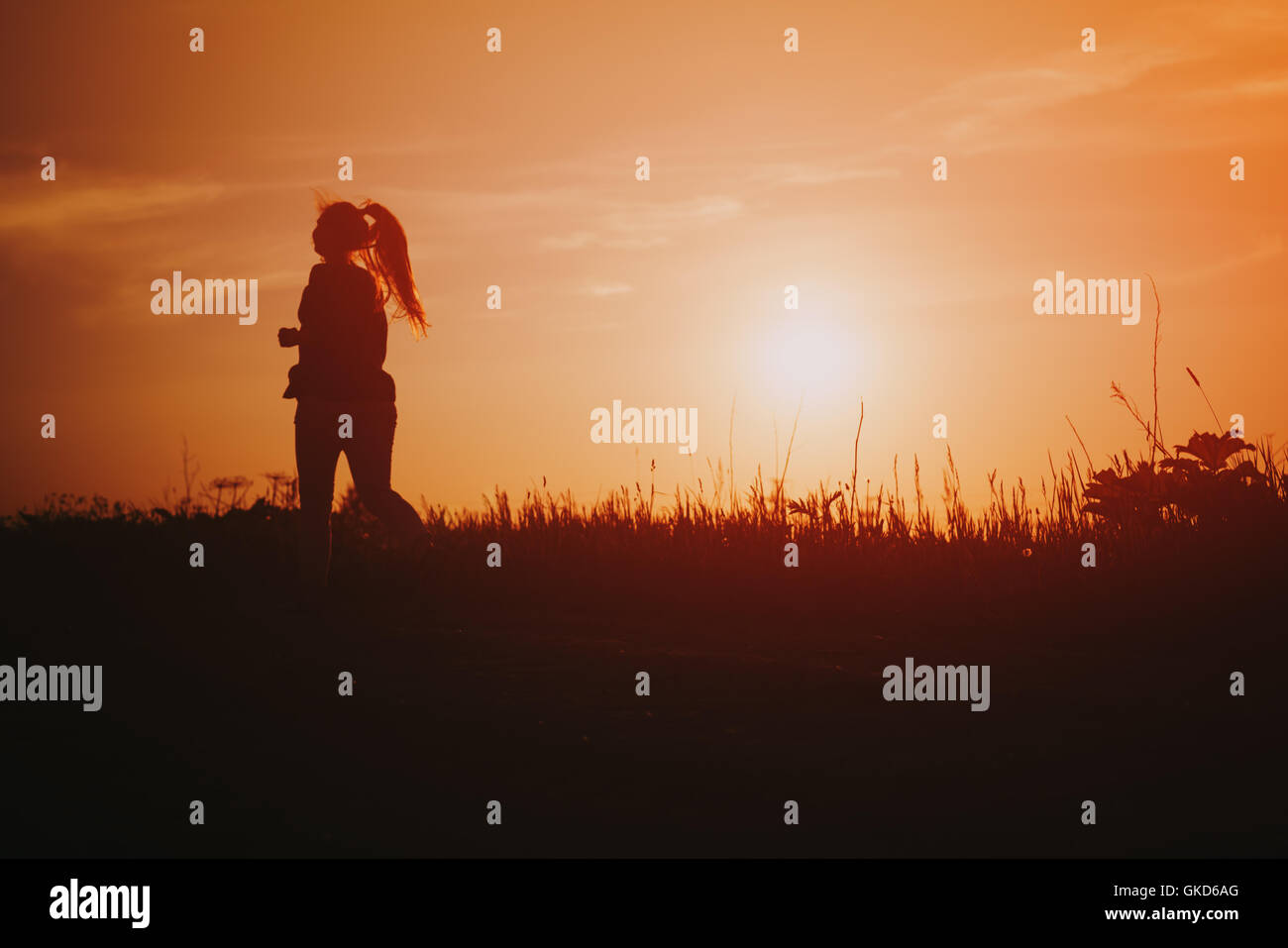 teenage girl runner countryside in sunset Stock Photo - Alamy