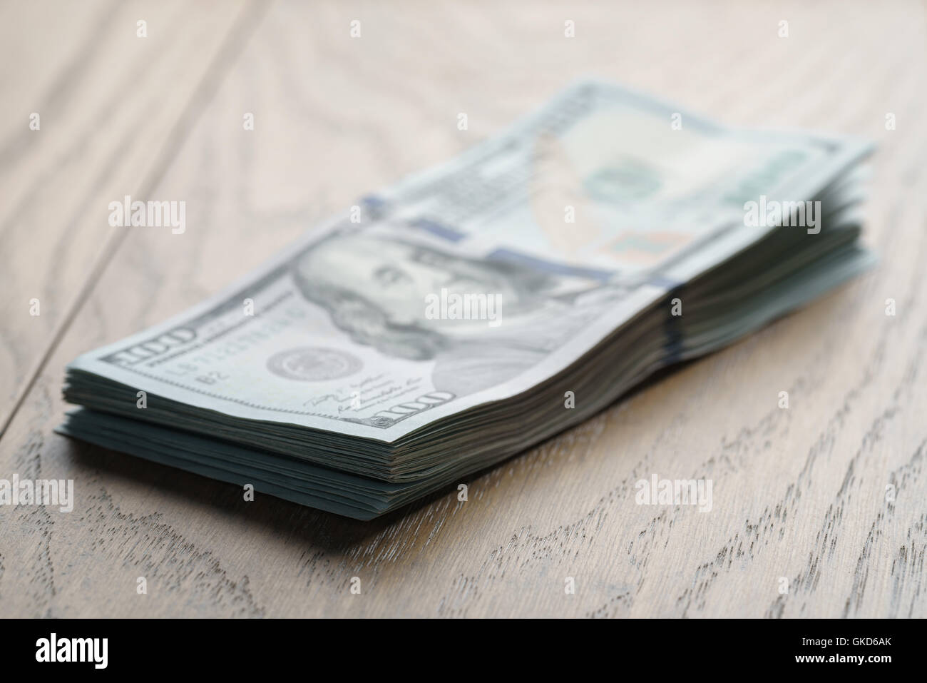 bunch of dollars on oak wood table Stock Photo - Alamy