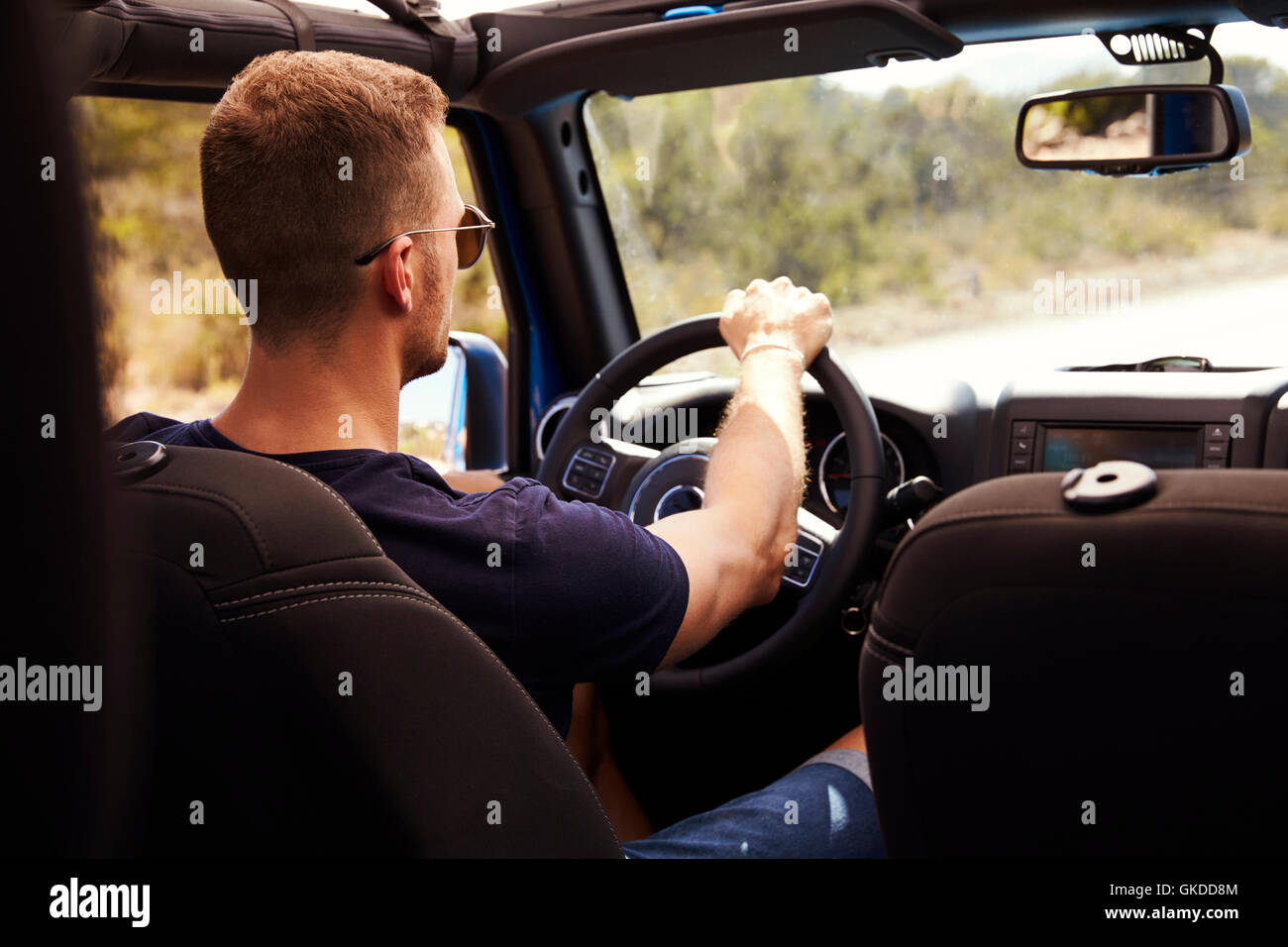 Man Driving Open Top Car On Country Road Stock Photo - Alamy