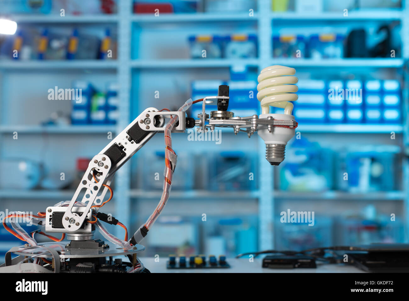 Robot arm with bulb lamp Stock Photo - Alamy