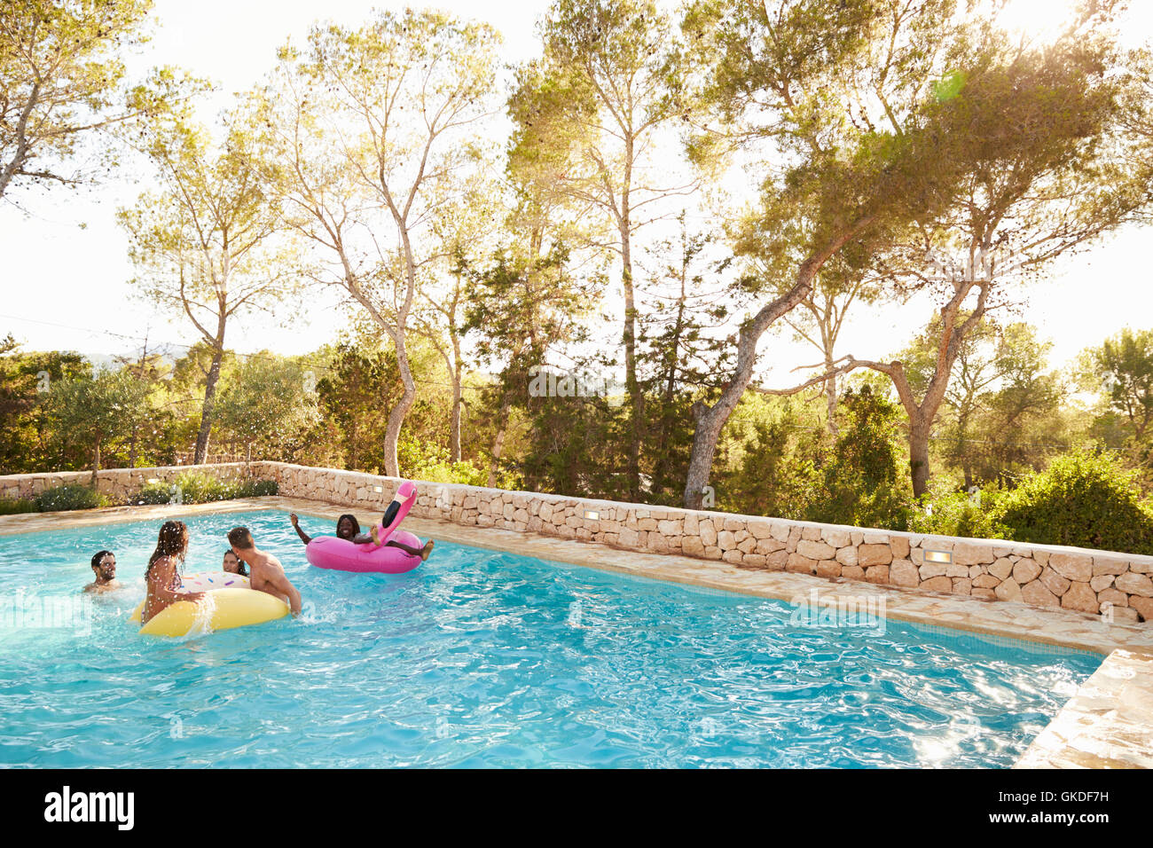 Friends relaxing in pool copy space hi-res stock photography and images ...