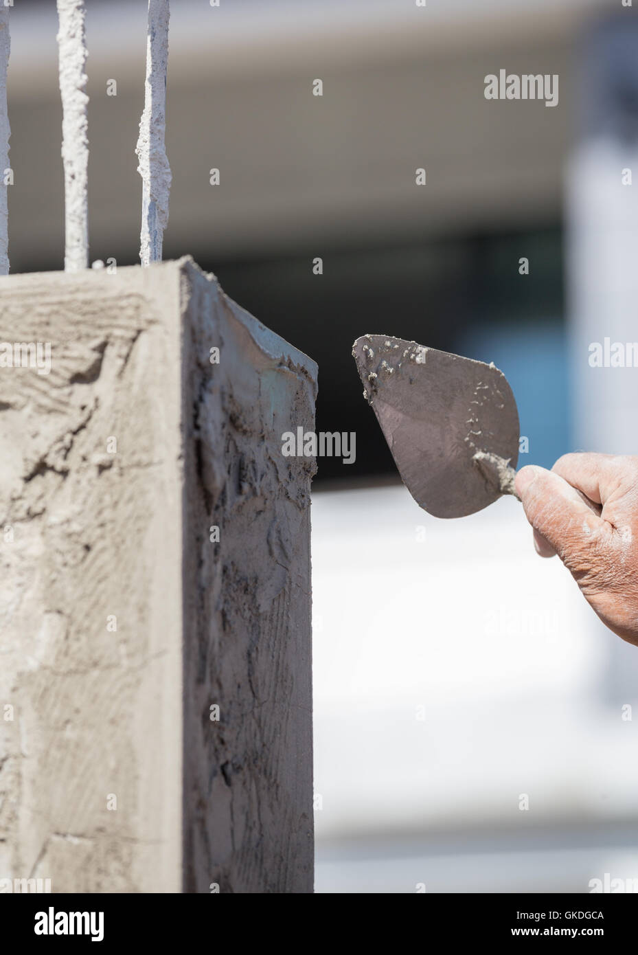 worker use trowel plastering the poles at construction site Stock Photo ...