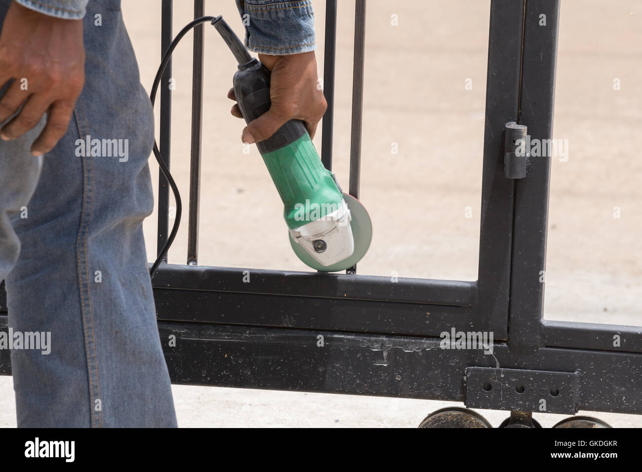 hand of worker using an angle grinder to grinding door frames Stock ...