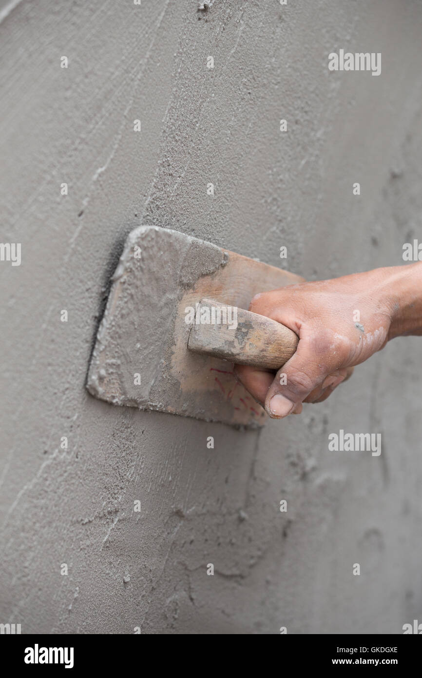 hand of builder worker use trowel plastering concrete at wall Stock ...