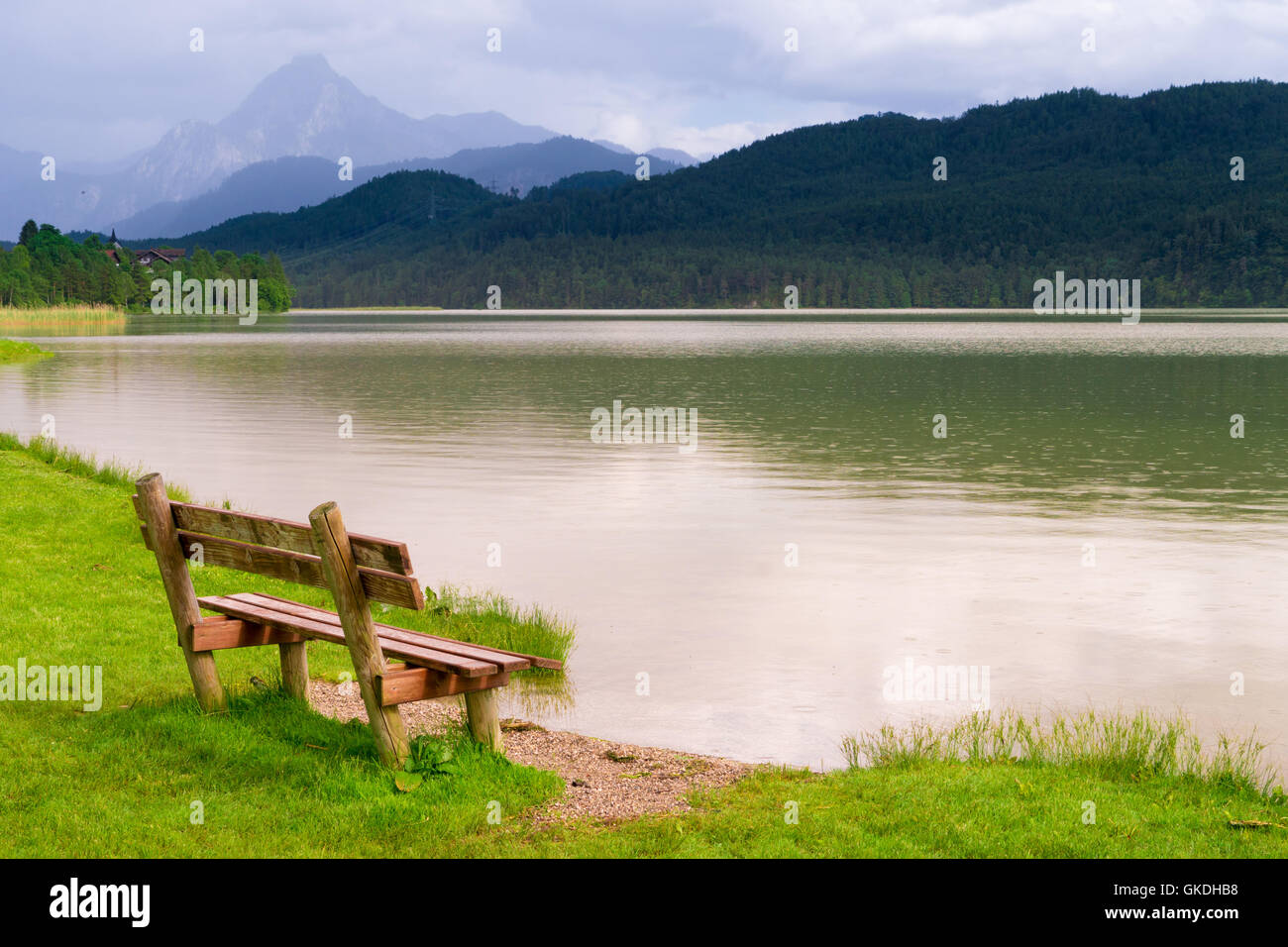 bench in green park and lake in alps Stock Photo - Alamy