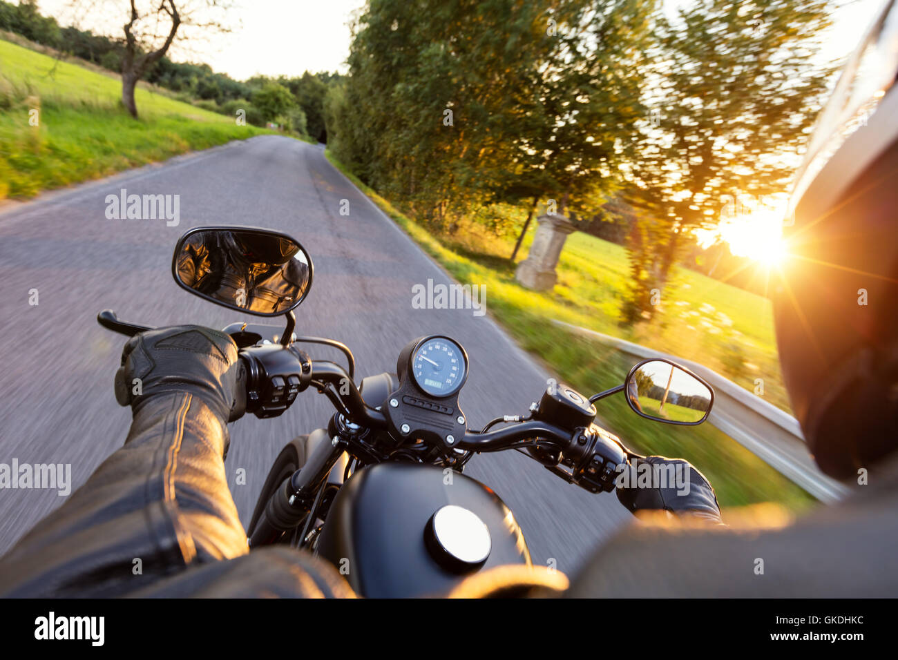 Motorcycle driver riding on motorway in beautiful sunset light. Shot ...