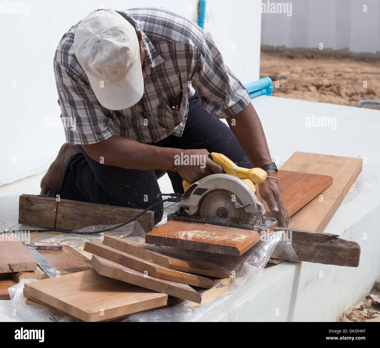 carpenter use electric saw to sawing wood board Stock Photo - Alamy