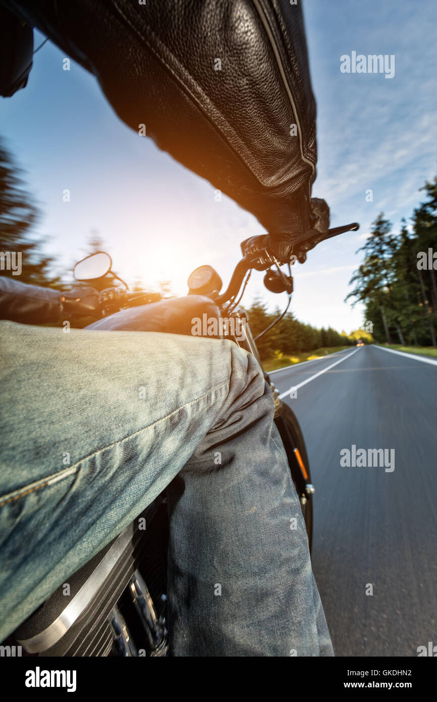 Motorcycle driver riding on motorway in beautiful sunset light. Shot ...