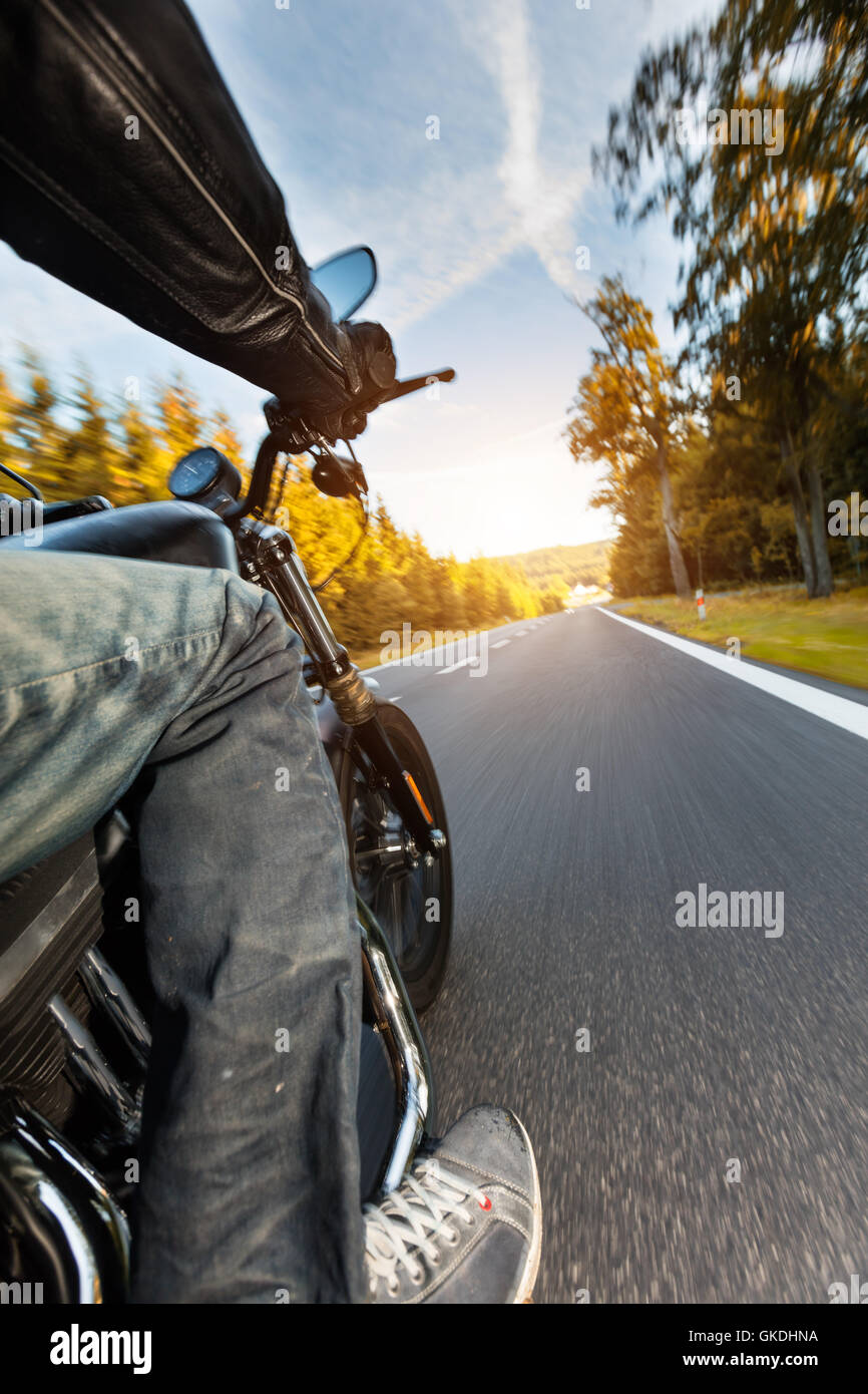 Motorcycle driver riding on motorway in beautiful sunset light. Shot ...