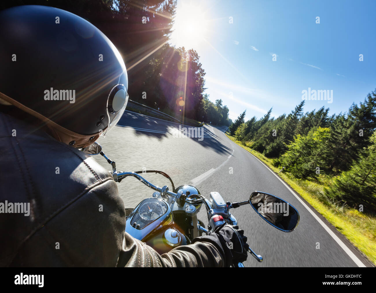 Motorcycle driver riding on motorway in beautiful sunset light. Shot ...