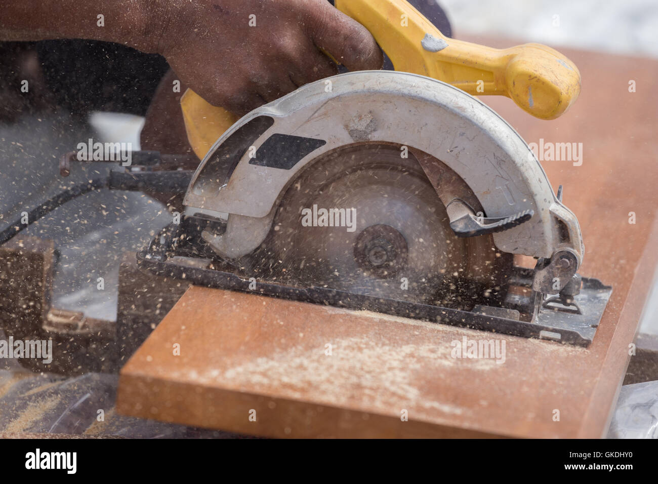 carpenter use electric saw to sawing wood board Stock Photo - Alamy