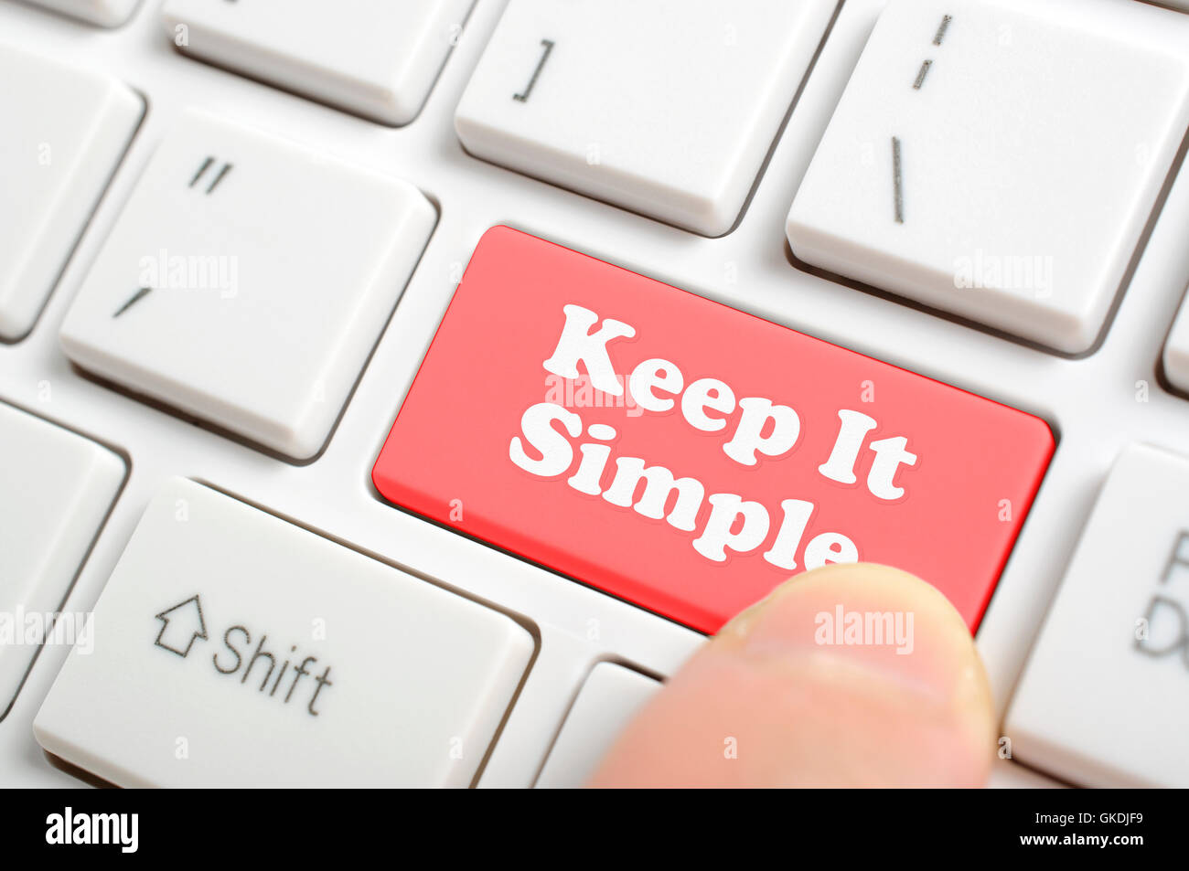 Pressing red keep it simple key on keyboard Stock Photo - Alamy