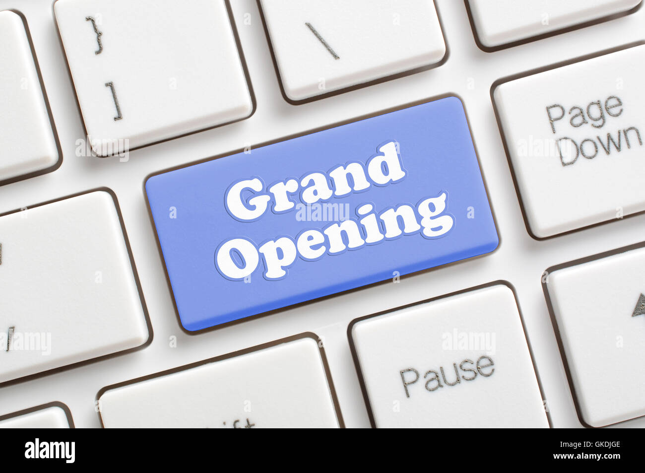 Blue grand opening key on keyboard Stock Photo - Alamy