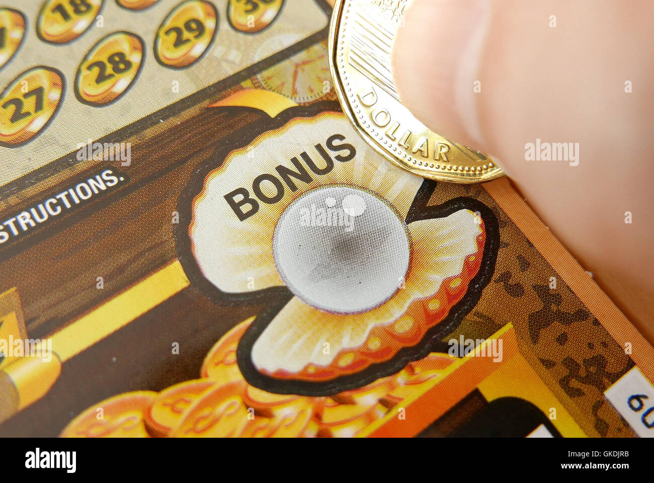 man scratching lottery ticket on bonus section. The British Columbia ...