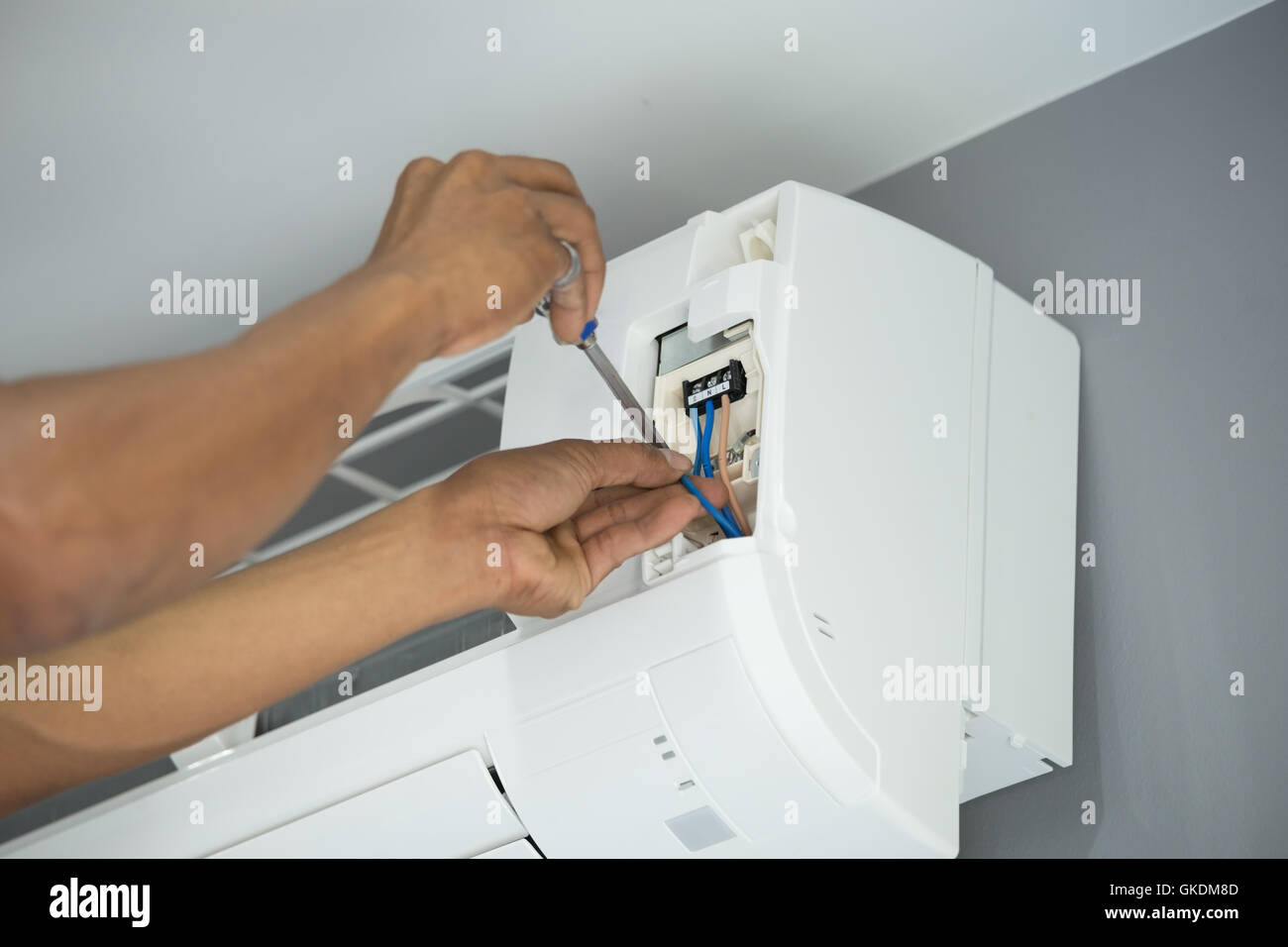 installation of the air conditioner, worker connects electric wires ...