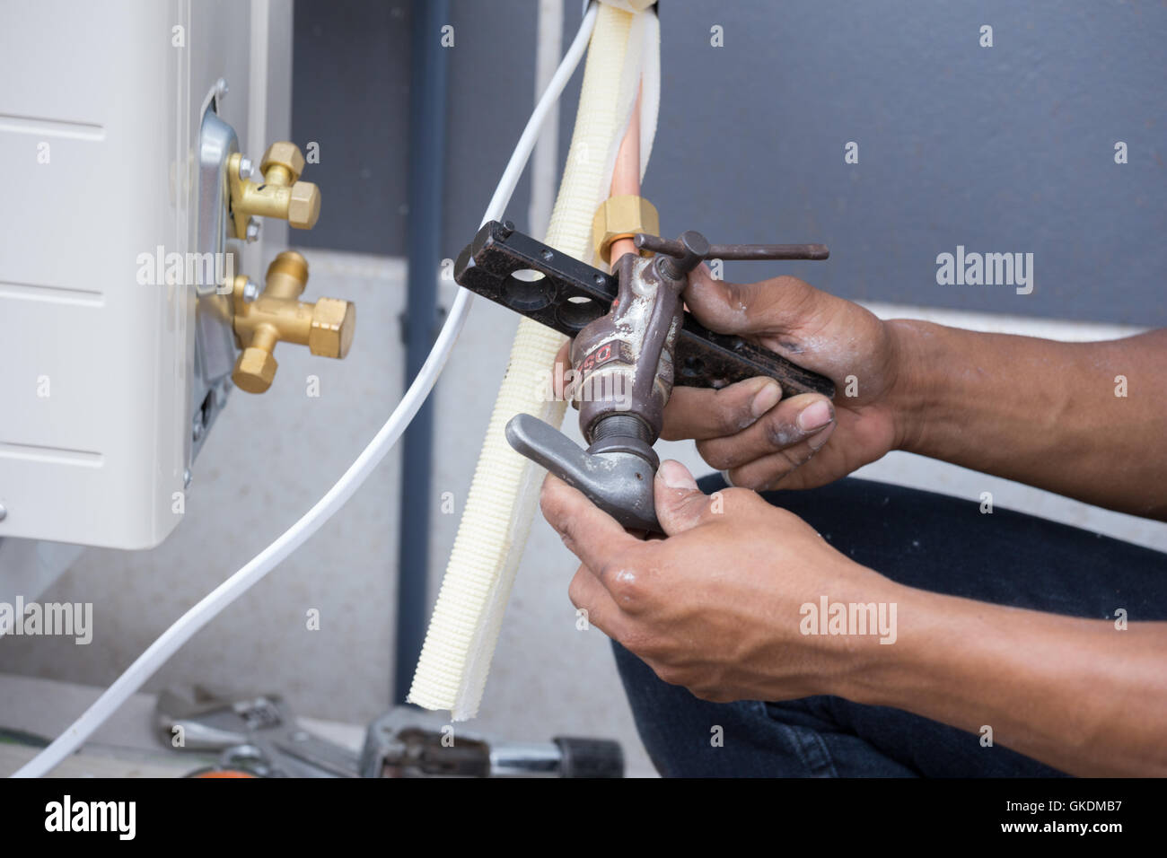 installation of the air conditioner, worker connects copper pipe Stock ...