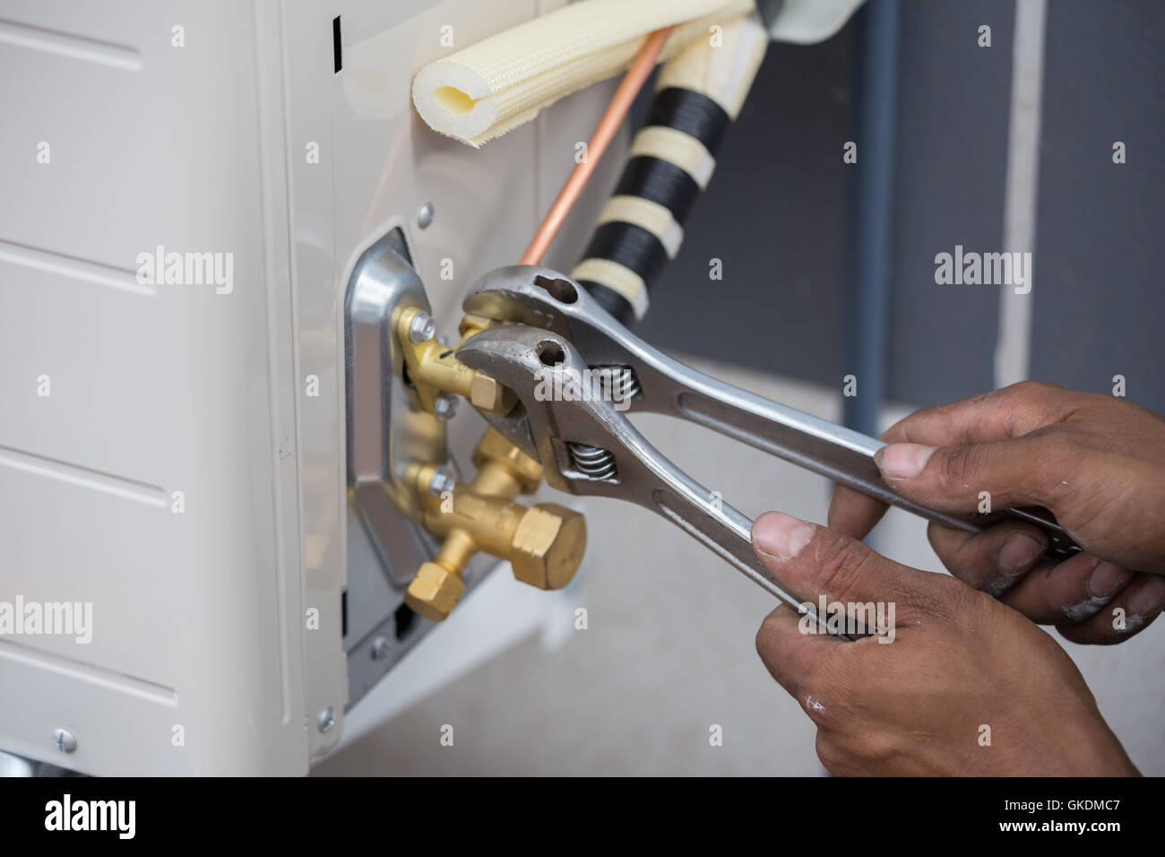 installation of the air conditioner, worker connects copper pipe Stock ...