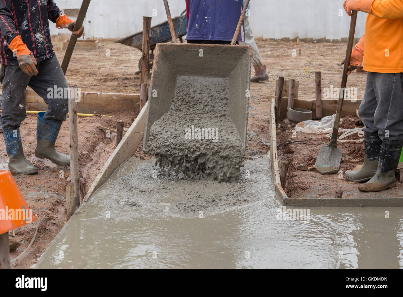 worker pouring cement from cart to floor at construction site Stock ...