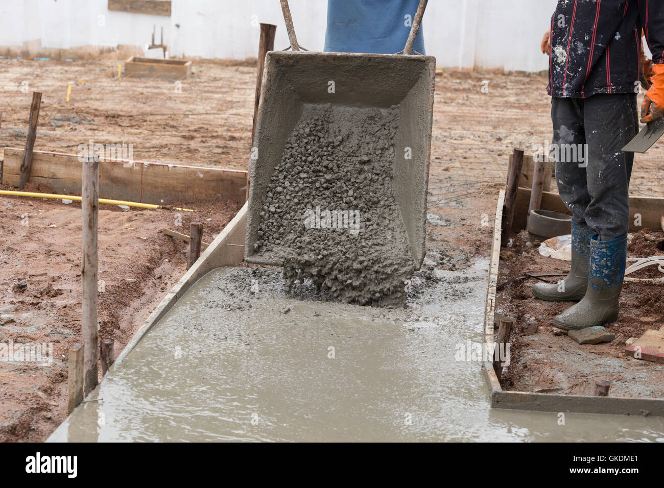 worker pouring cement from cart to floor at construction site Stock ...