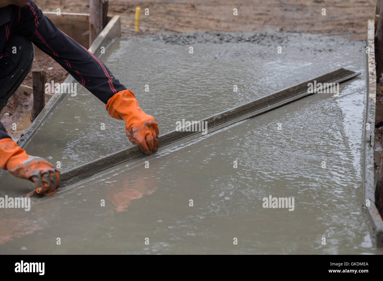 Plasterer screed concrete for floor at construction Stock Photo - Alamy