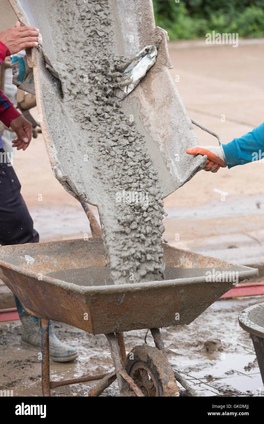 pouring wet cement to cart at construction site Stock Photo - Alamy