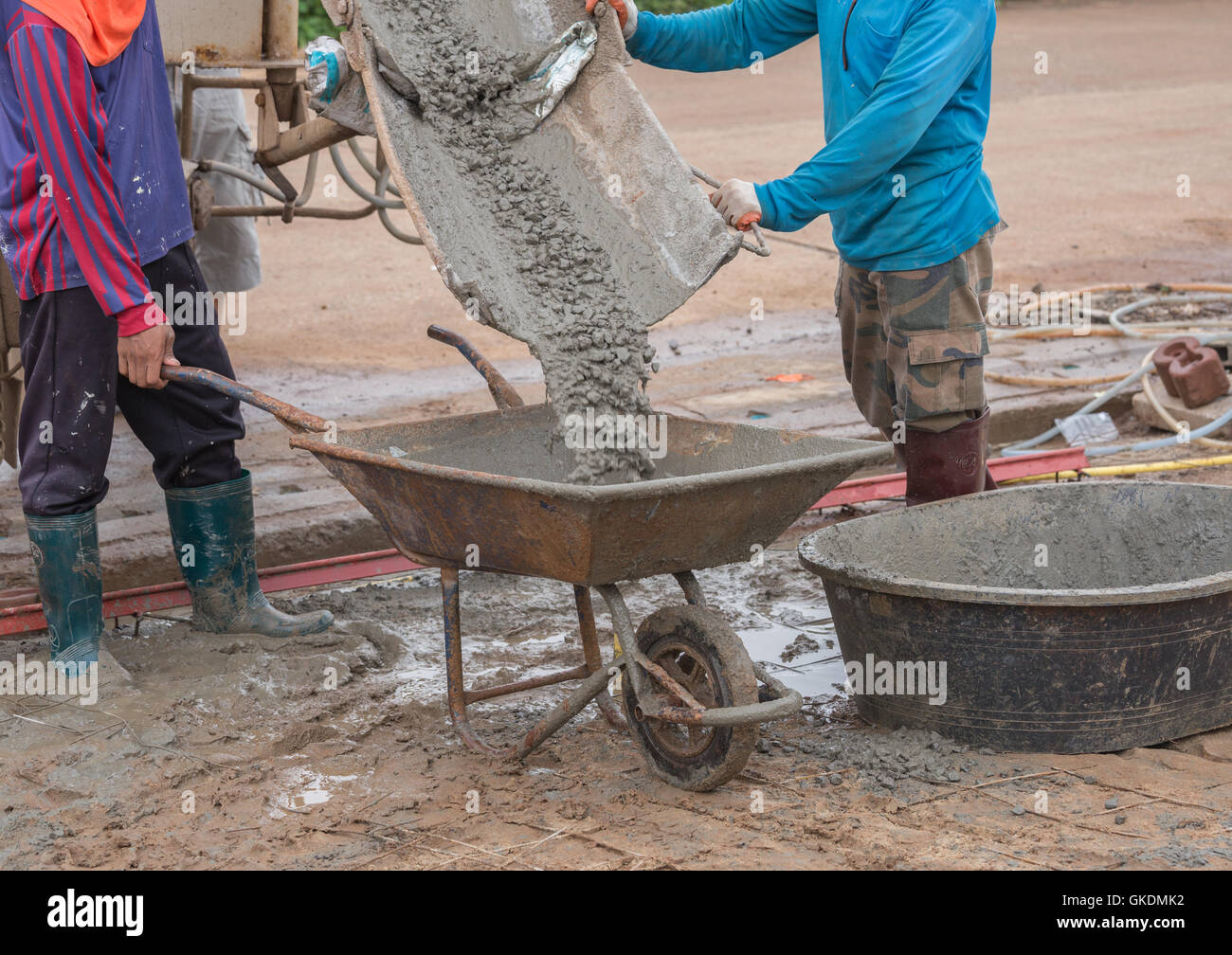 pouring wet cement to cart at construction site Stock Photo - Alamy