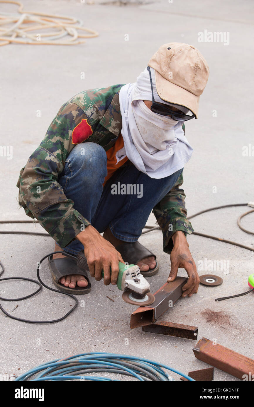 worker using an angle grinder to grinding metal Stock Photo - Alamy