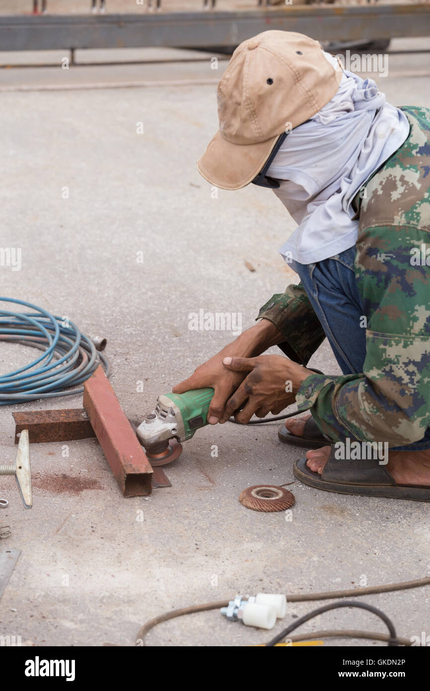 worker using an angle grinder to grinding metal Stock Photo - Alamy