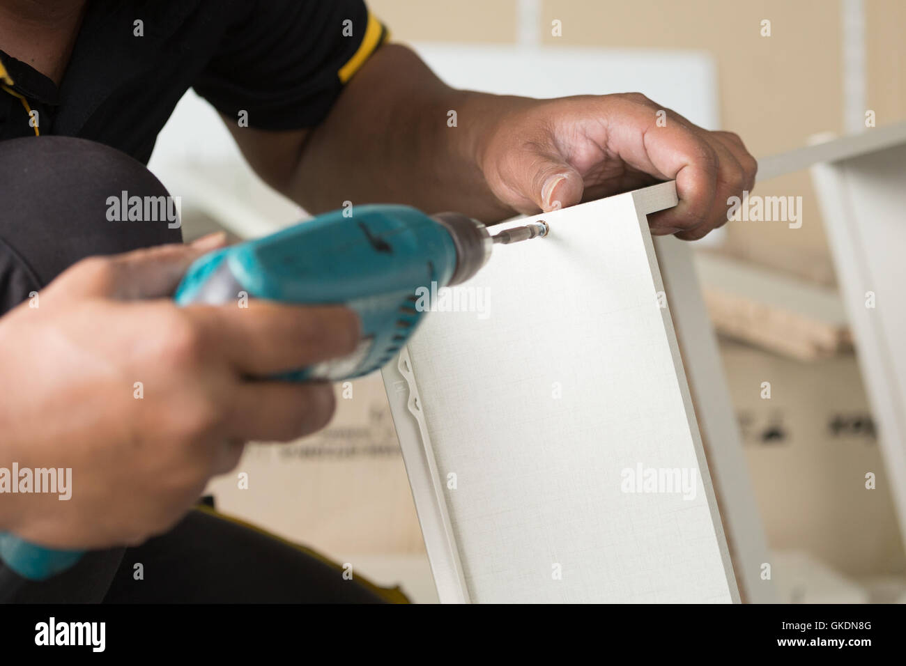 Assembling new furniture with a screwdriver Stock Photo - Alamy