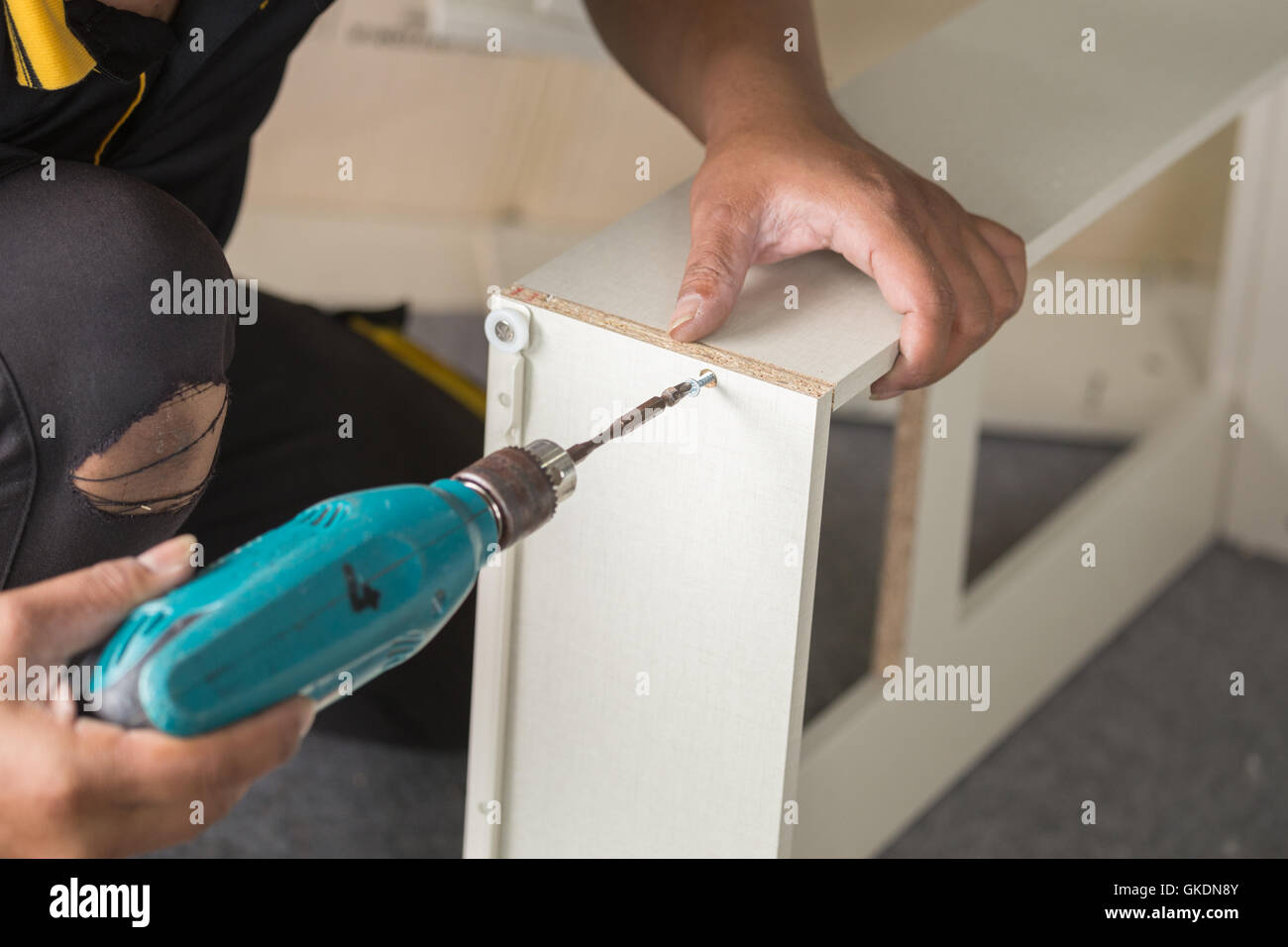 Assembling new furniture with a screwdriver Stock Photo - Alamy