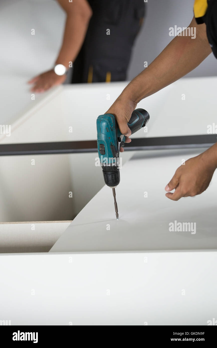 Assembling new furniture with a screwdriver Stock Photo - Alamy