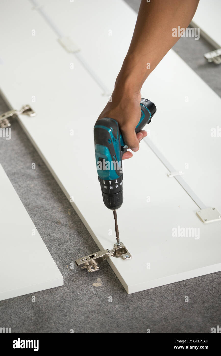 Assembling new furniture with a screwdriver Stock Photo - Alamy