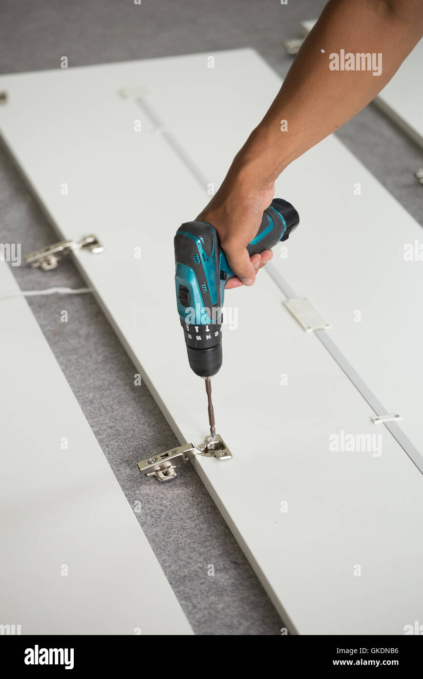 Assembling new furniture with a screwdriver Stock Photo - Alamy
