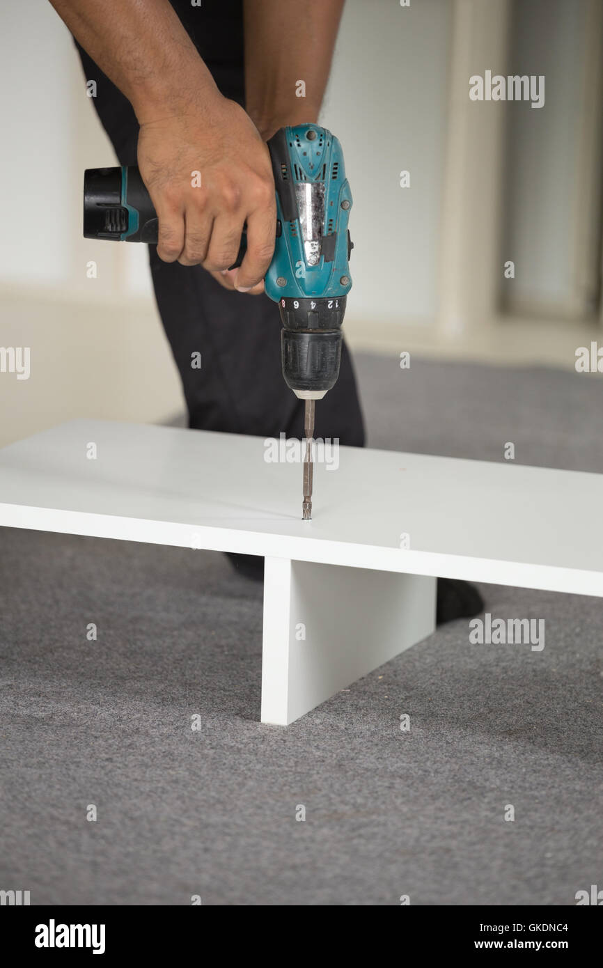 Assembling new furniture with a screwdriver Stock Photo - Alamy