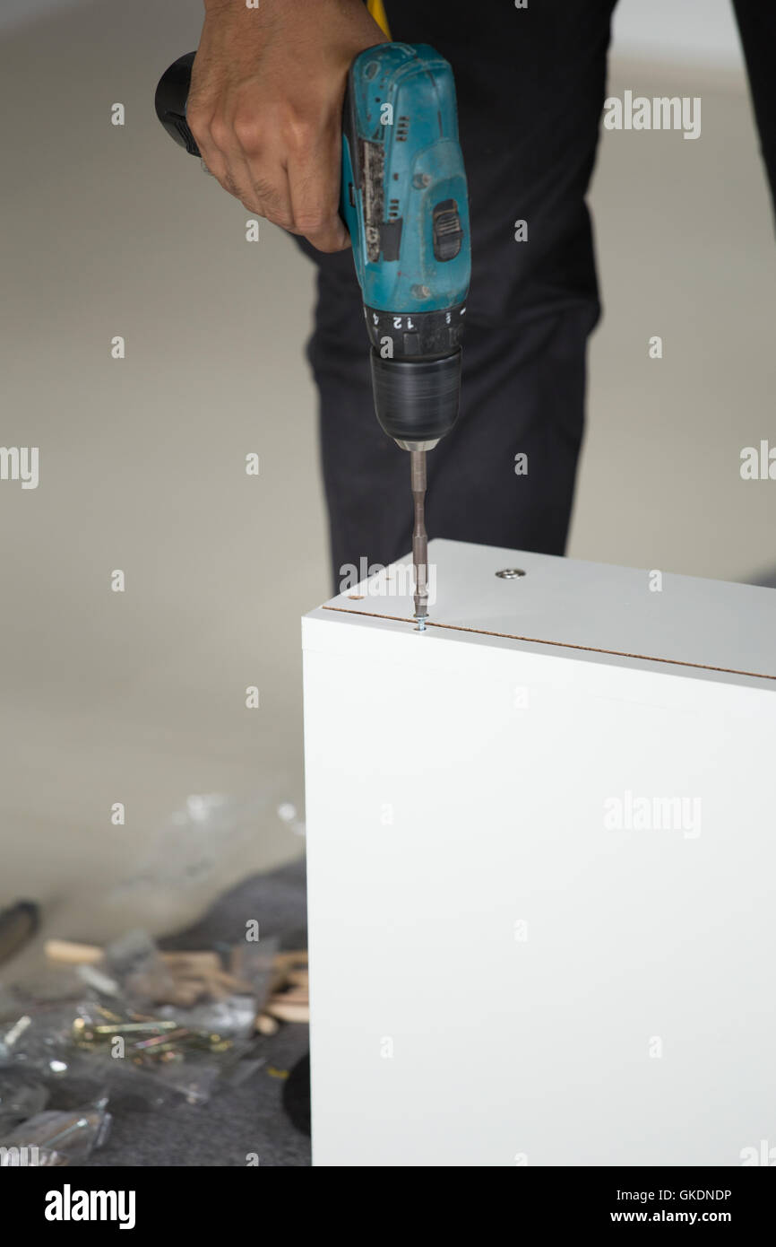 Assembling new furniture with a screwdriver Stock Photo - Alamy