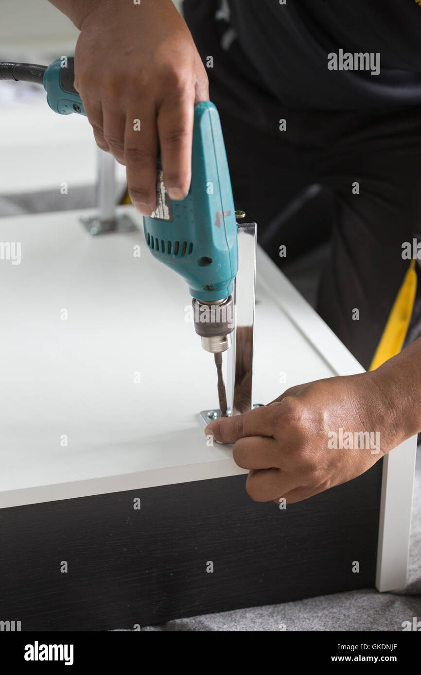 Assembling new furniture with a screwdriver Stock Photo - Alamy