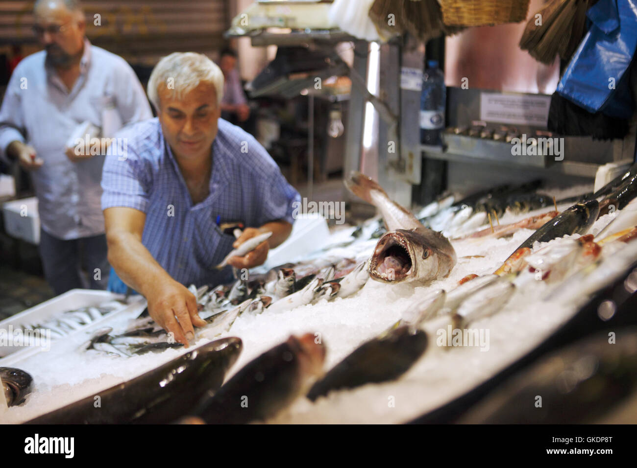 Fishmonger stall holder prepares his display of fish for sale in ...