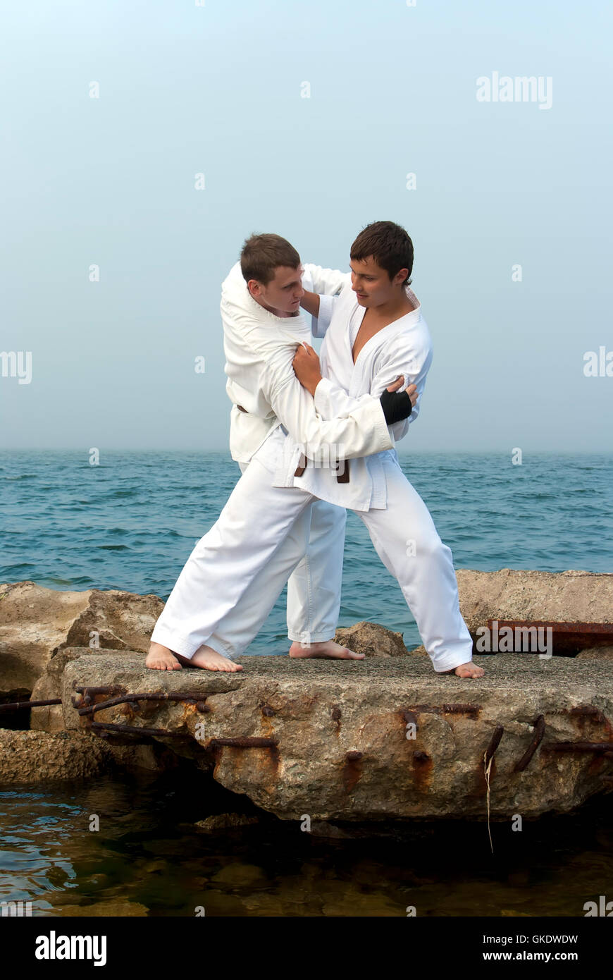 two karateka fight on the banks of the misty sea Stock Photo - Alamy