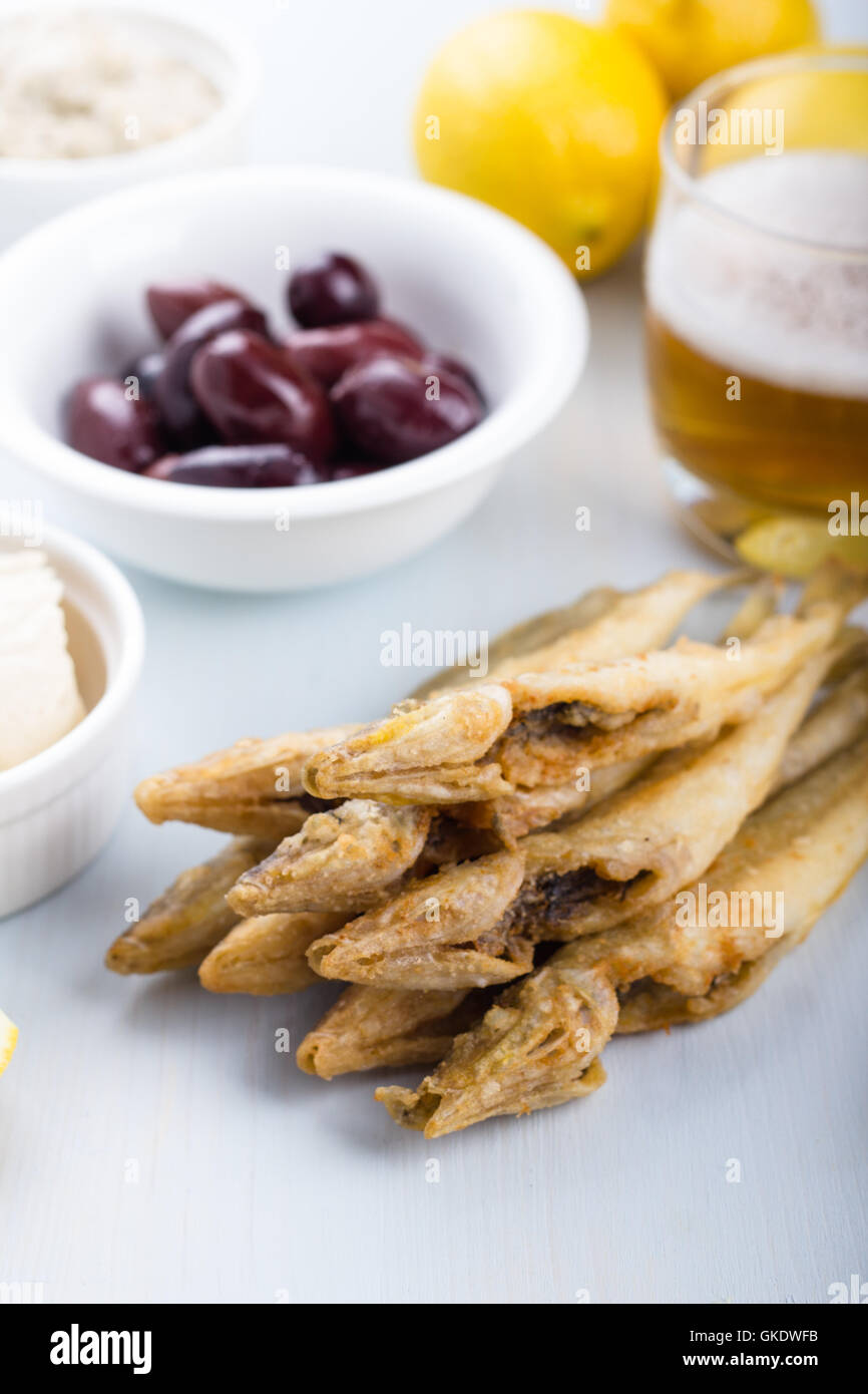 Fried ladyfish with lemon, beer, olives and hoummous and mutabel Stock ...
