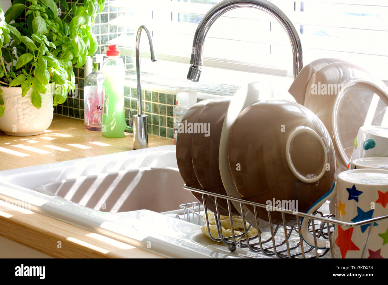 Kitchen sink and washing up in summer sunlight Stock Photo - Alamy