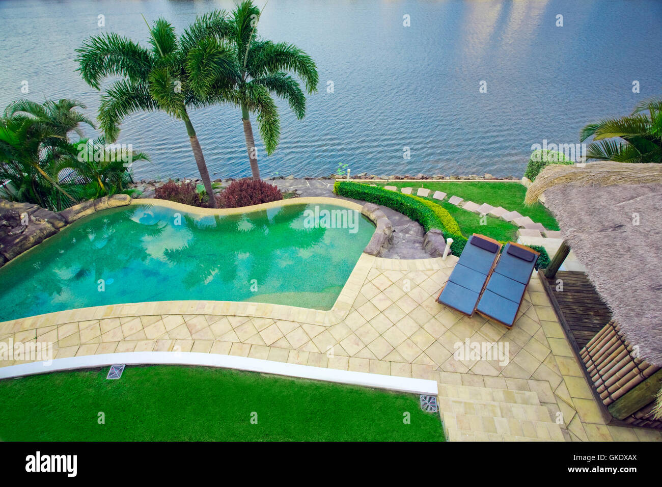 Waterfront Mansion with Pool and Bali hut overlooking the canal Stock ...