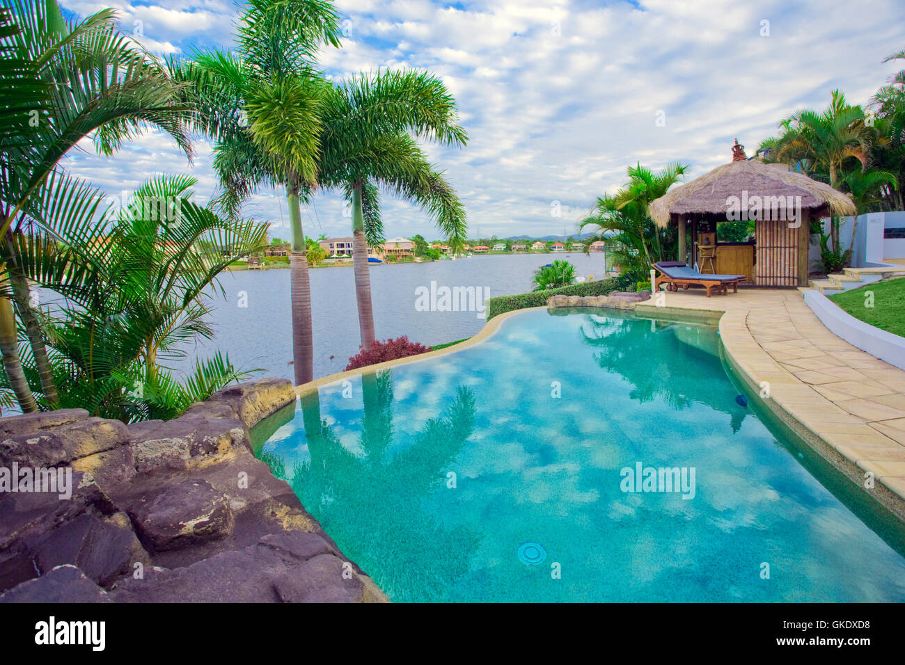 Waterfront Mansion with Pool and Bali hut overlooking the canal Stock ...