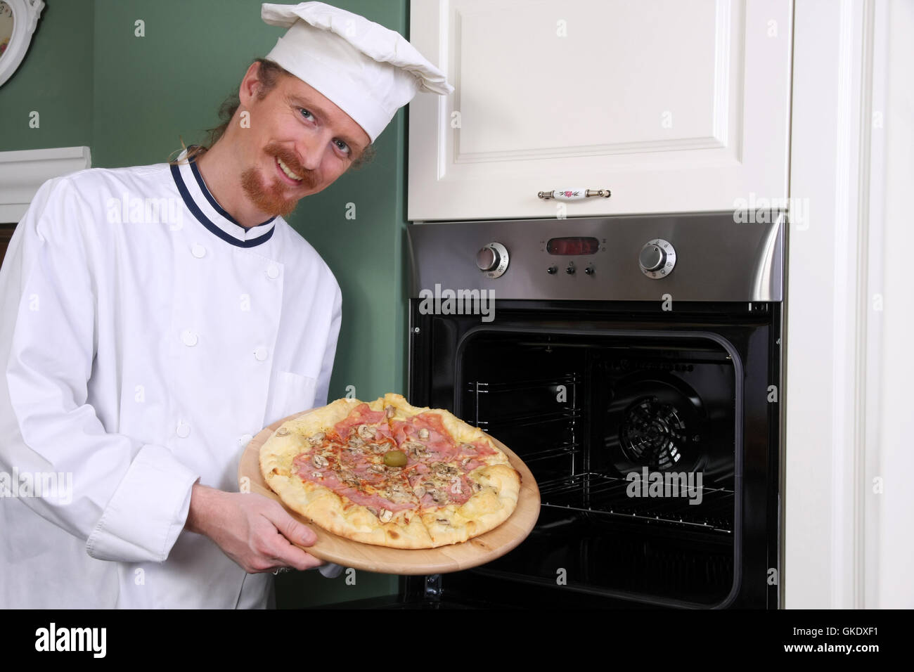 young chef with italian pizza in kitchen Stock Photo - Alamy