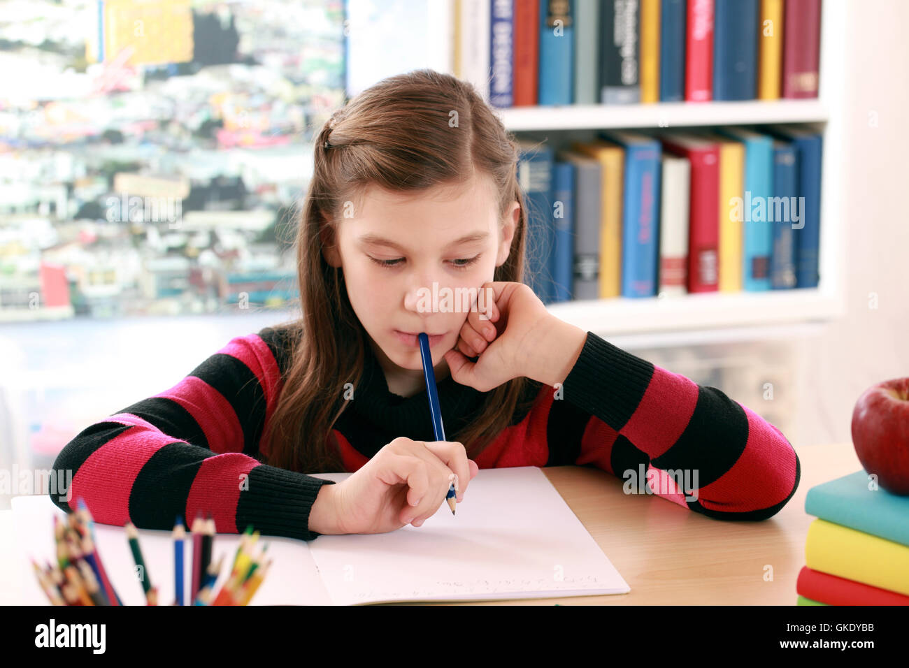 girl doing homework at desk Stock Photo - Alamy