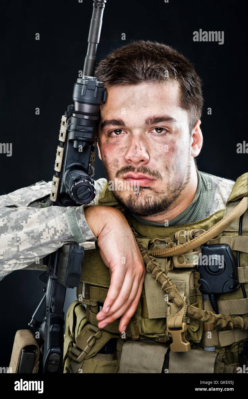 Soldier posing with a gun Stock Photo - Alamy