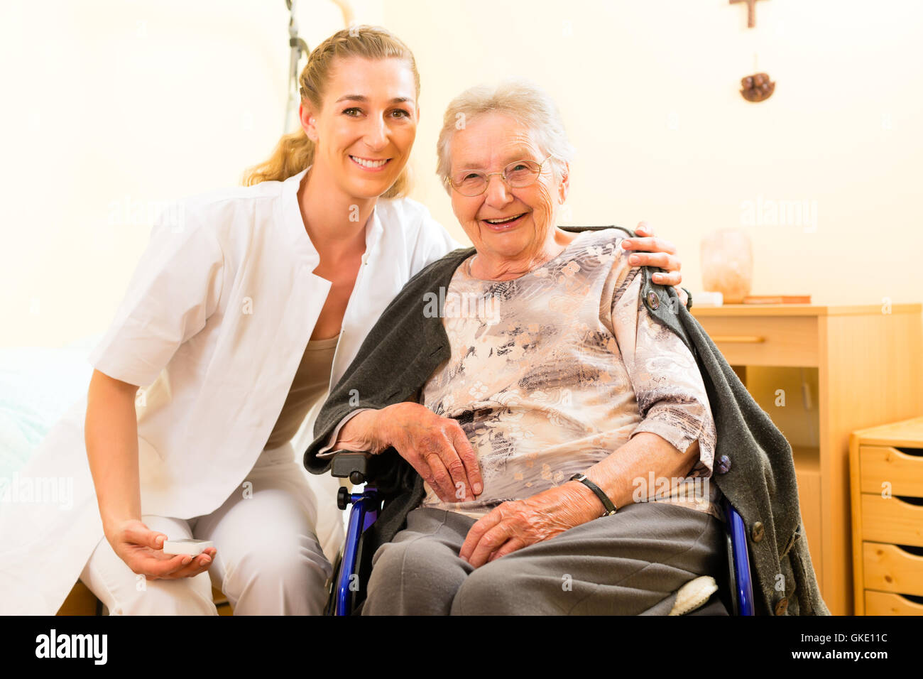 age and care - nurse and a senior citizen retirement home Stock Photo ...