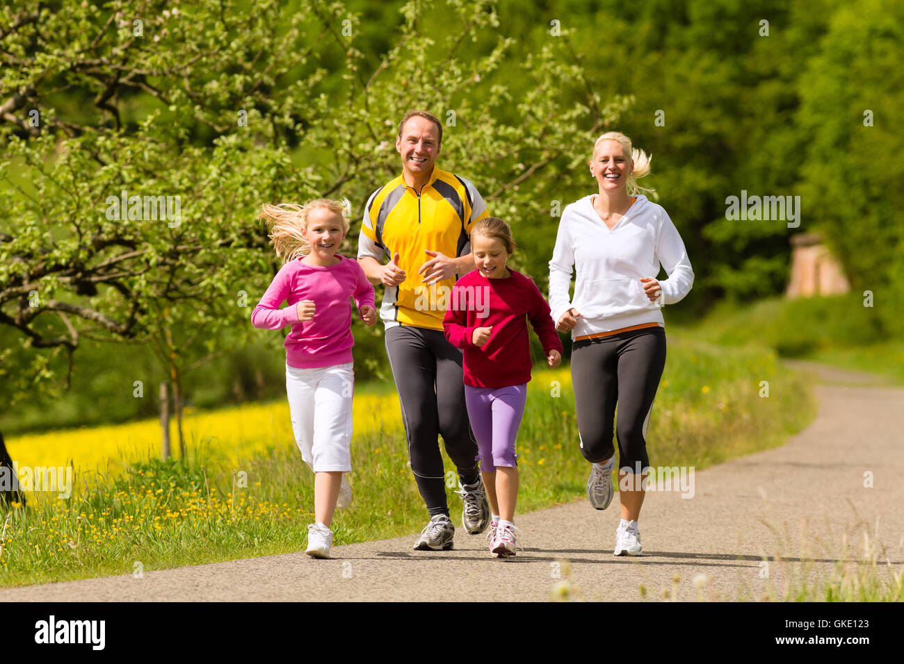 family jogging as a sport in nature Stock Photo - Alamy